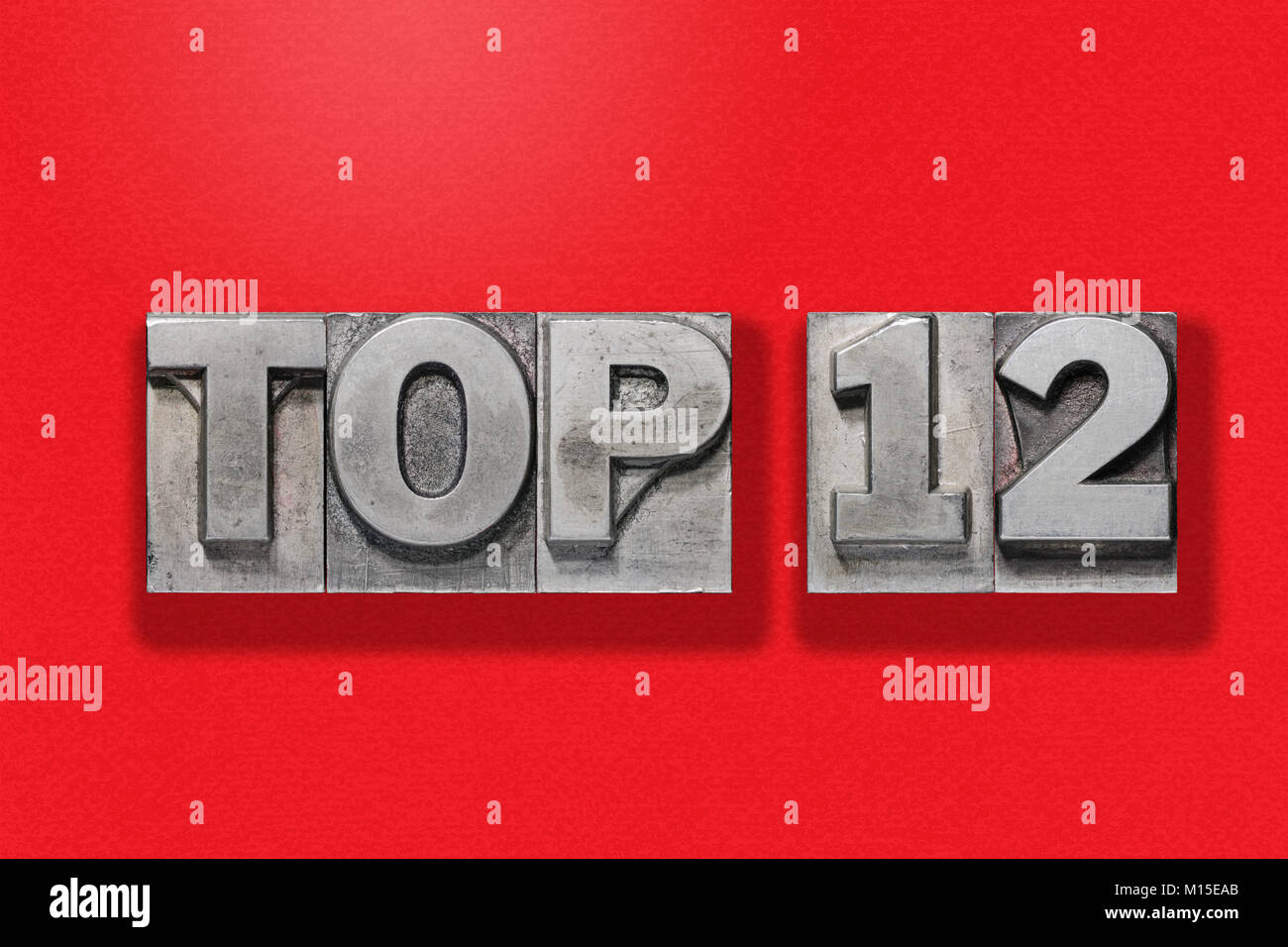 top twelve metallic letterpress numbers assembled on red textured ...
