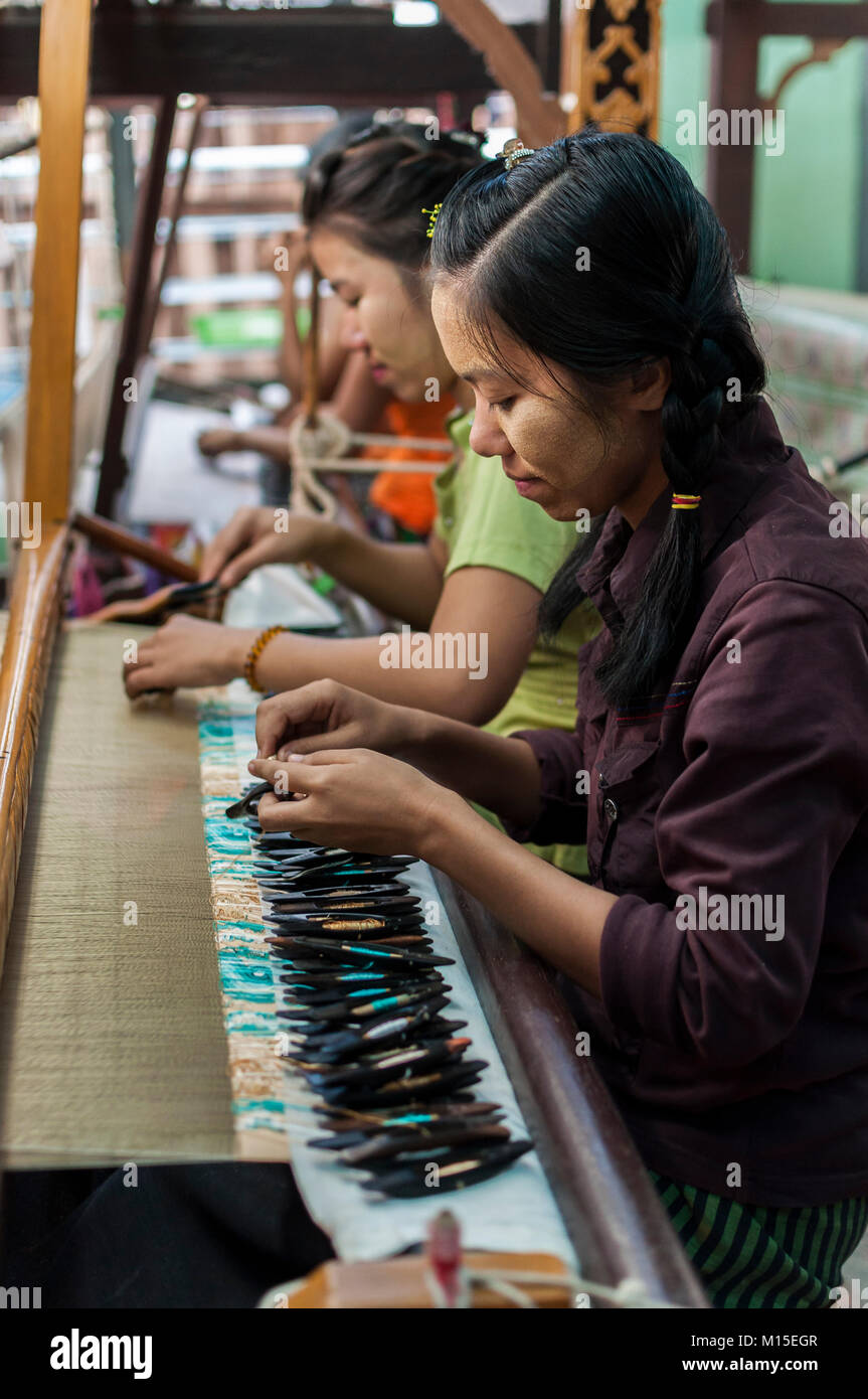 MANDALAY, MYANMAR - NOVEMBER, 2016: Manual workers in textile factory ...