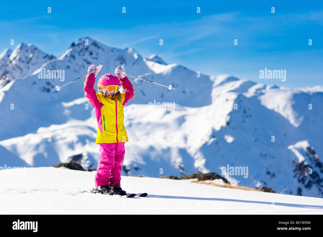 Child skiing in mountains. Active toddler kid with safety helmet ...