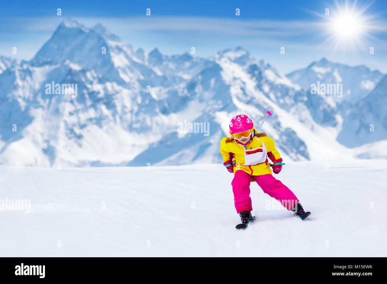 Child skiing in mountains. Active toddler kid with safety helmet ...