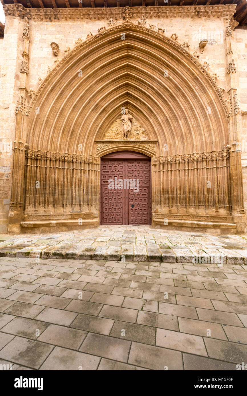 Massive Spanish church door with intricately carved surround and paving ...
