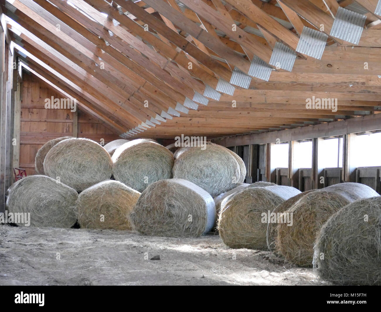 Stacks of Rolled-up Hay Inside a Wooden Barn Stock Photo - Alamy