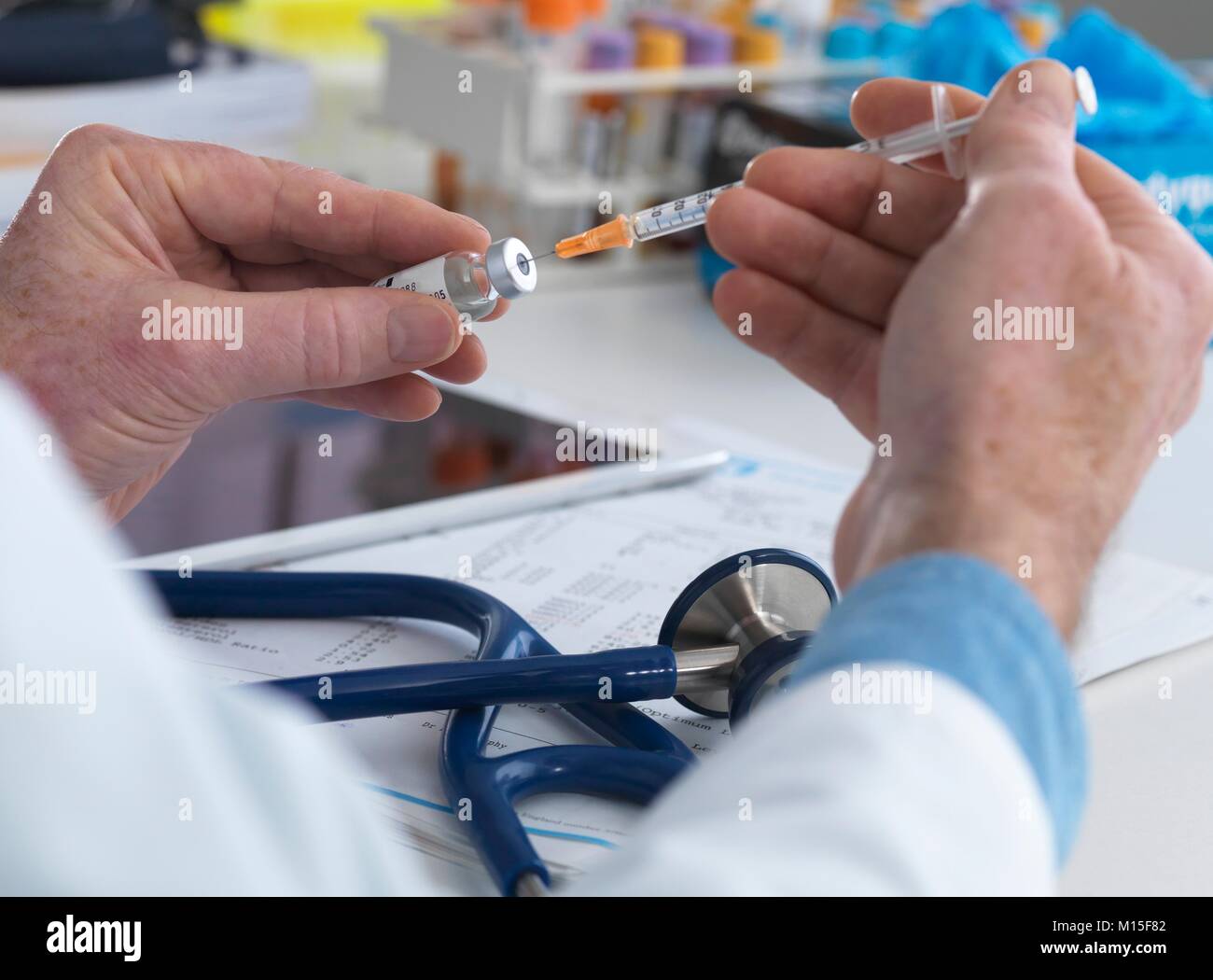 MODEL RELEASED. Doctor preparing a syringe ready for injection Stock ...