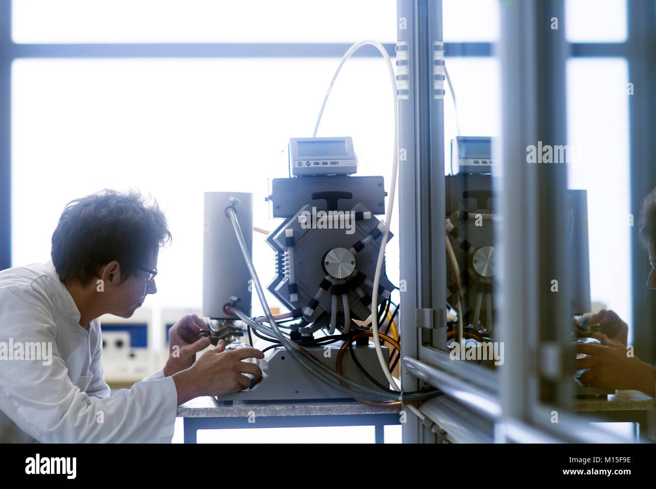 Chemist setting up a vacuum pump in a pharmaceutical laboratory Stock ...