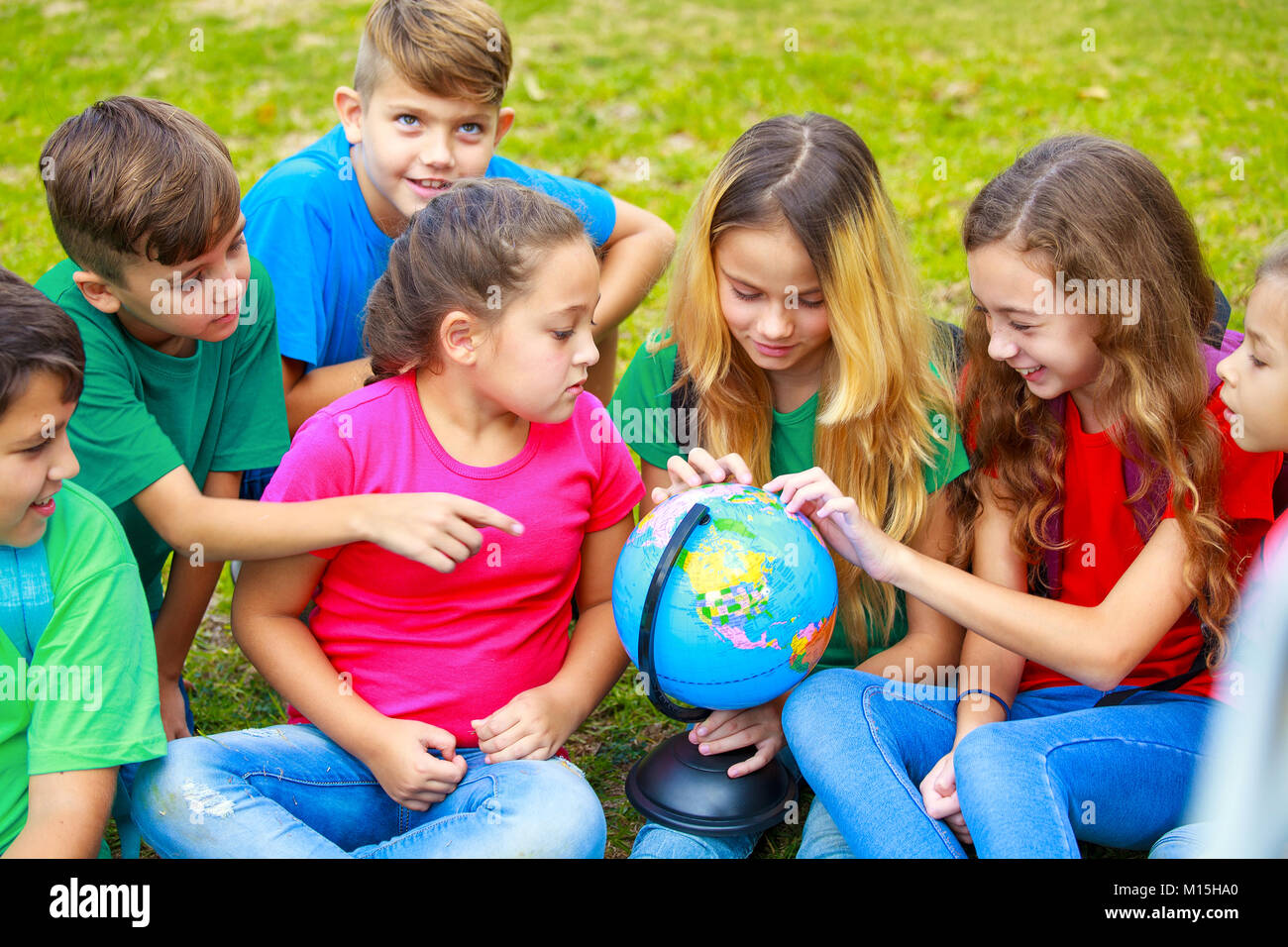 Children with a globe are learning geography at the park Stock Photo ...