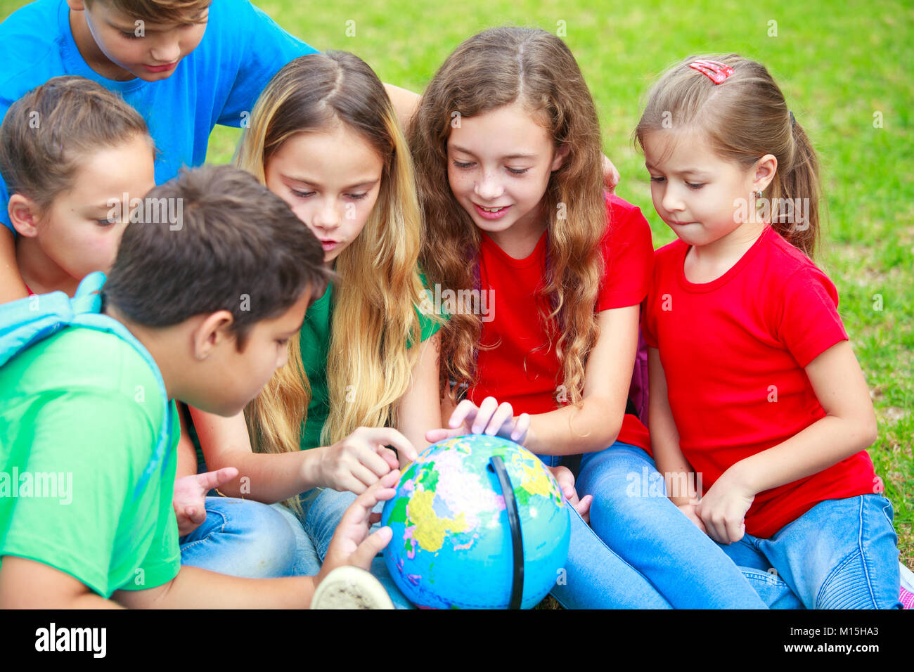 Children with a globe are learning geography at the park Stock Photo ...