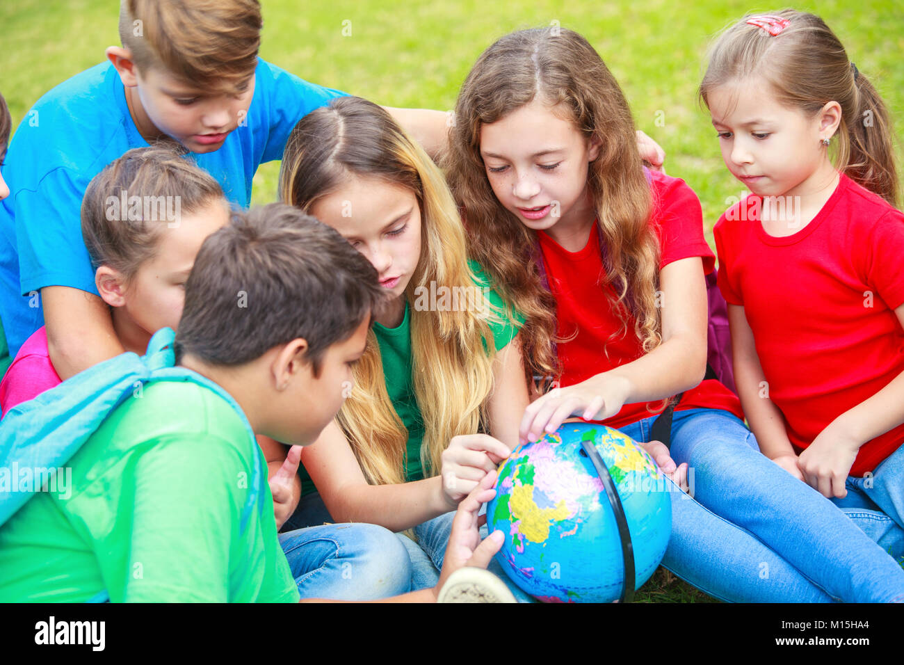 Children with a globe are learning geography at the park Stock Photo ...