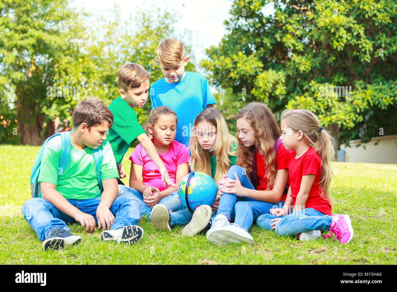Children with a globe are learning geography at the park Stock Photo ...