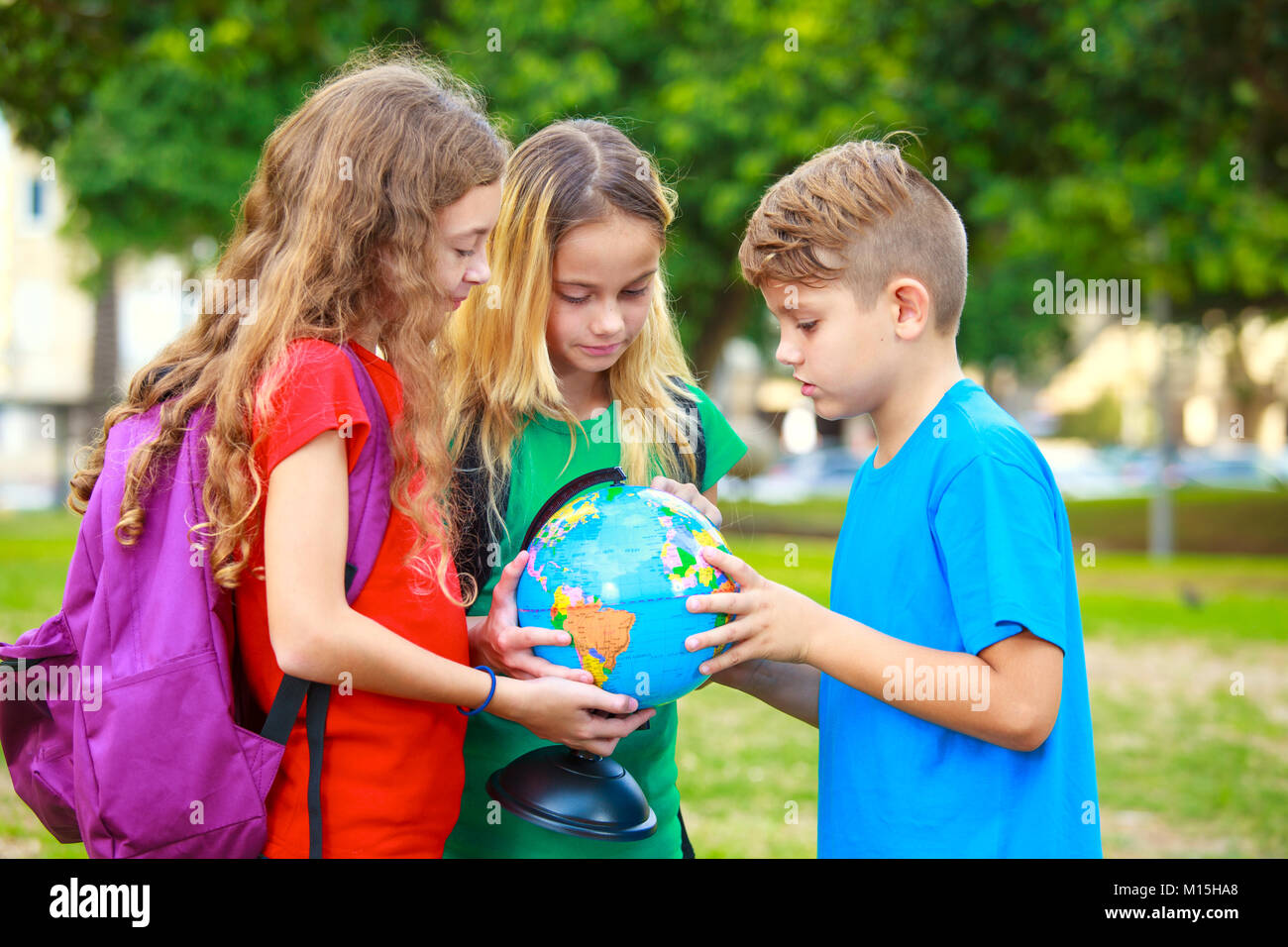 Children with a globe are learning geography at the park Stock Photo ...