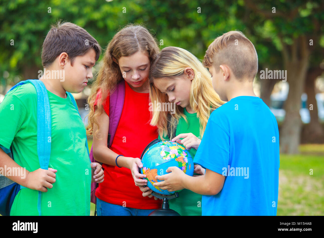 Children with a globe are learning geography at the park Stock Photo ...