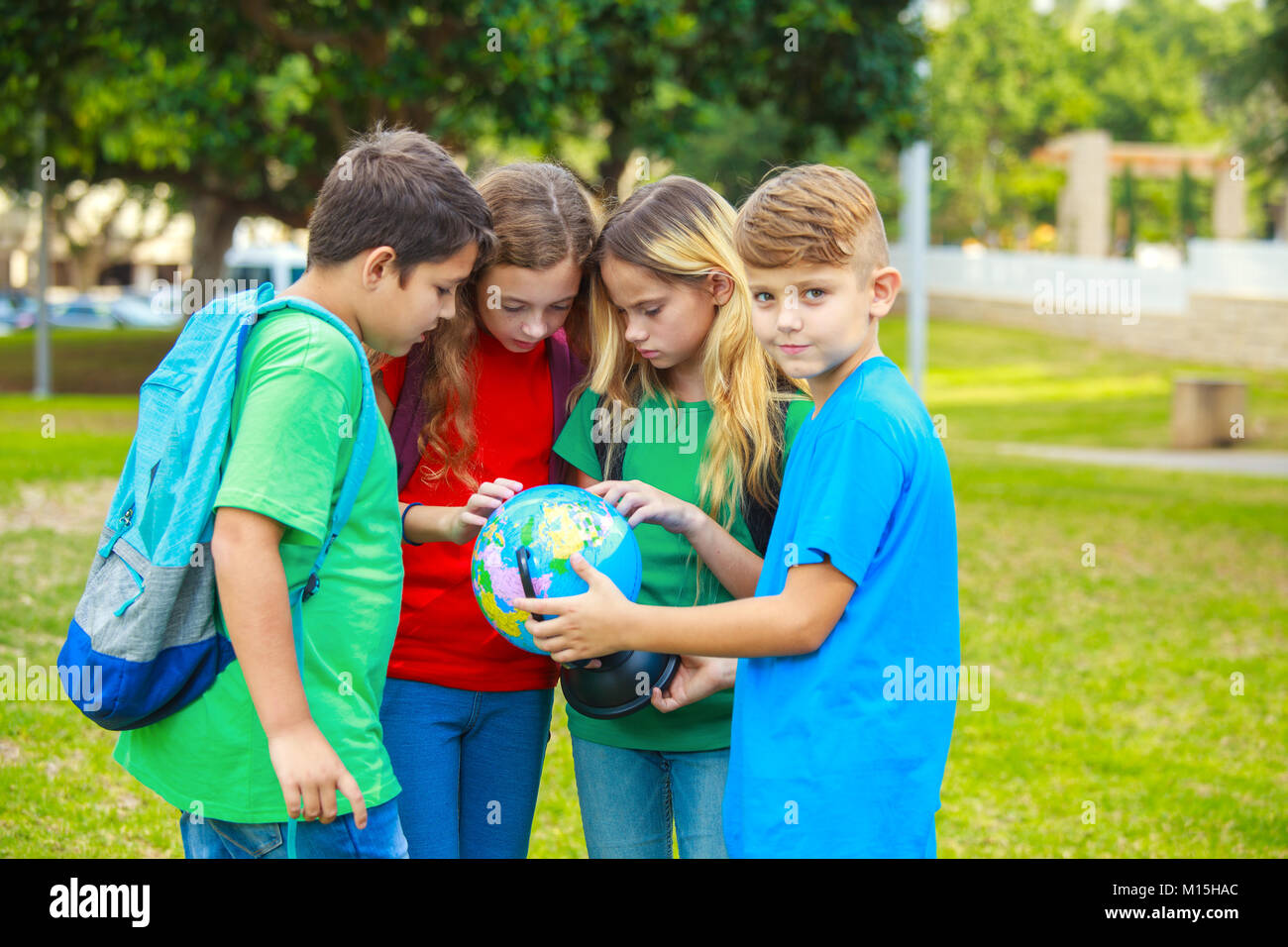 Children with a globe are learning geography at the park Stock Photo ...