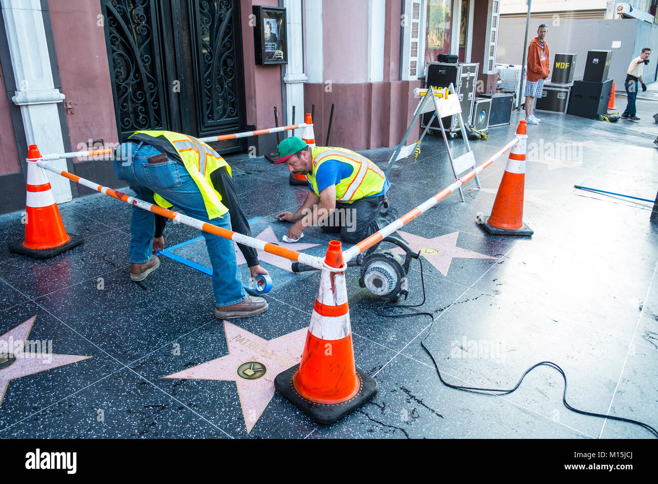 Construction workers install an additional Star in the Hollywood Walk ...
