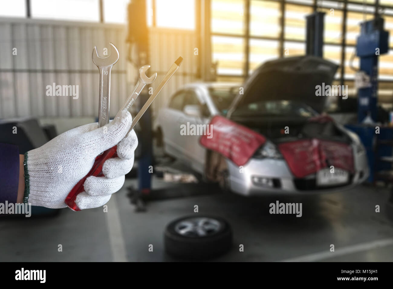 Mechanic repairing a car in garage Auto repair car engine Stock Photo ...
