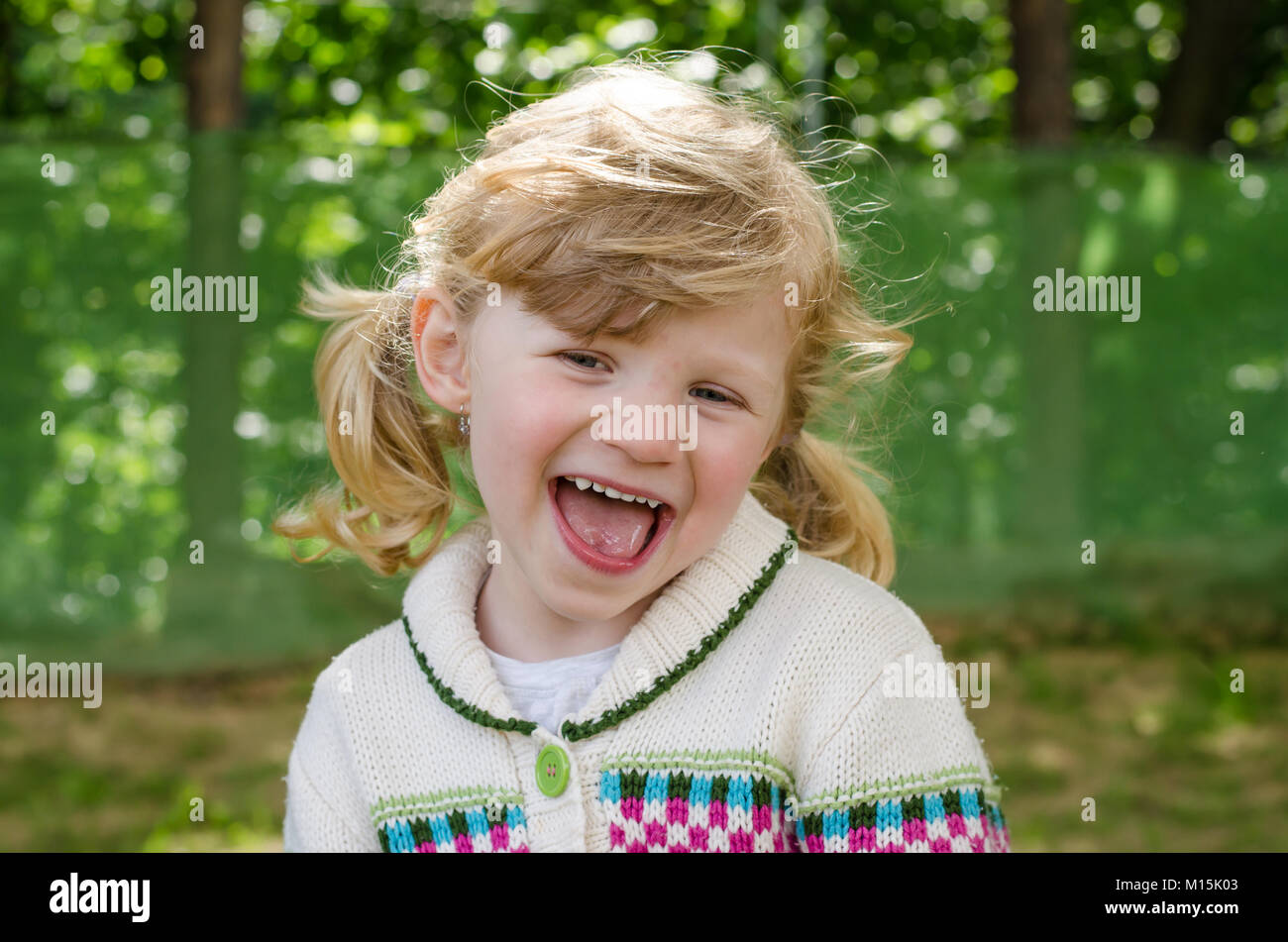 happy beautiful blond girl laughing Stock Photo - Alamy