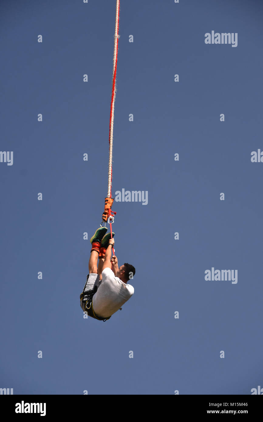 Young man bungee jumper hanging on a cord Stock Photo - Alamy