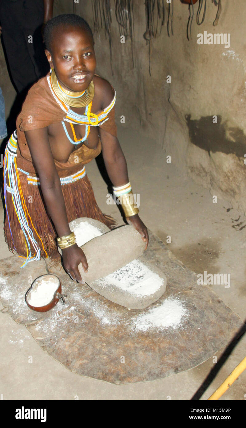 Datoga woman in traditional leather dress adorned with beads and brass ...