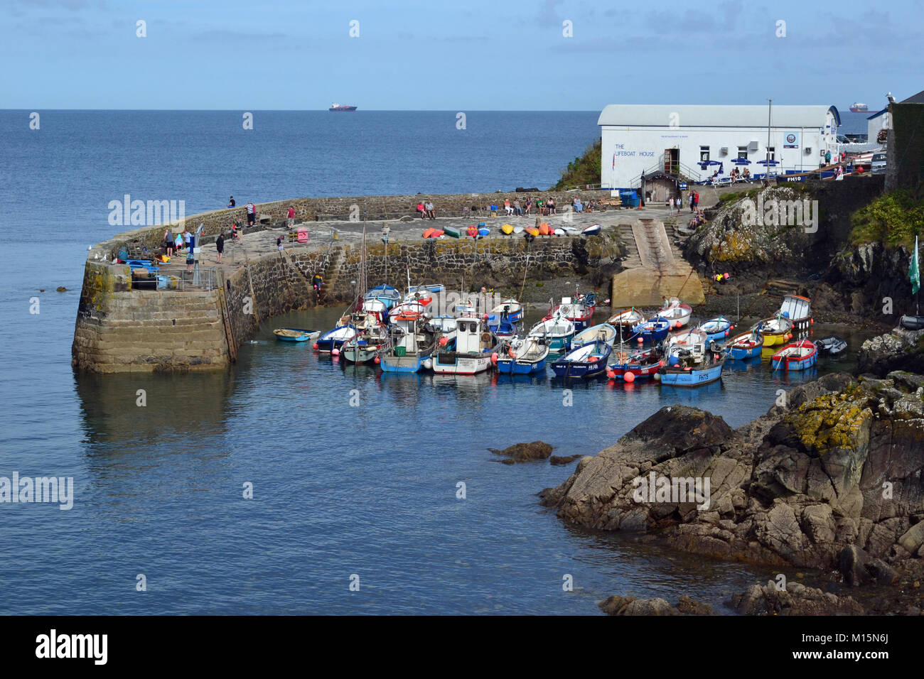 The Lifeboat House Restaurant and colourful boats in Coverack Harbour ...