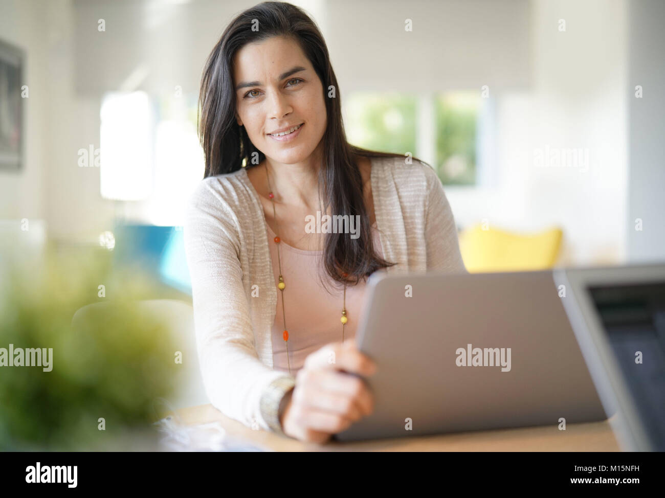 Portrait of brunette girl working on laptop computer Stock Photo - Alamy
