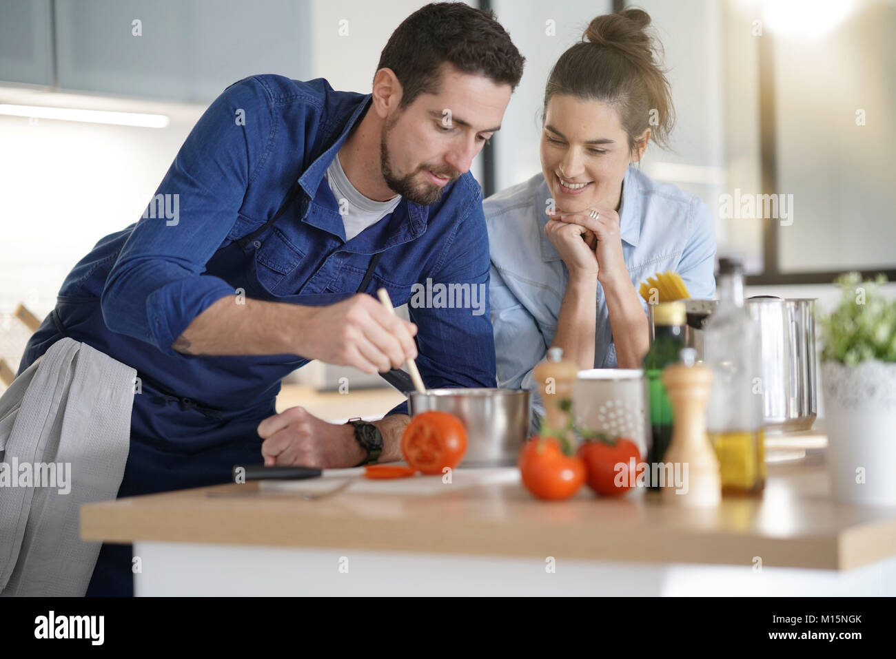 Couple at home having fun cooking together Stock Photo - Alamy