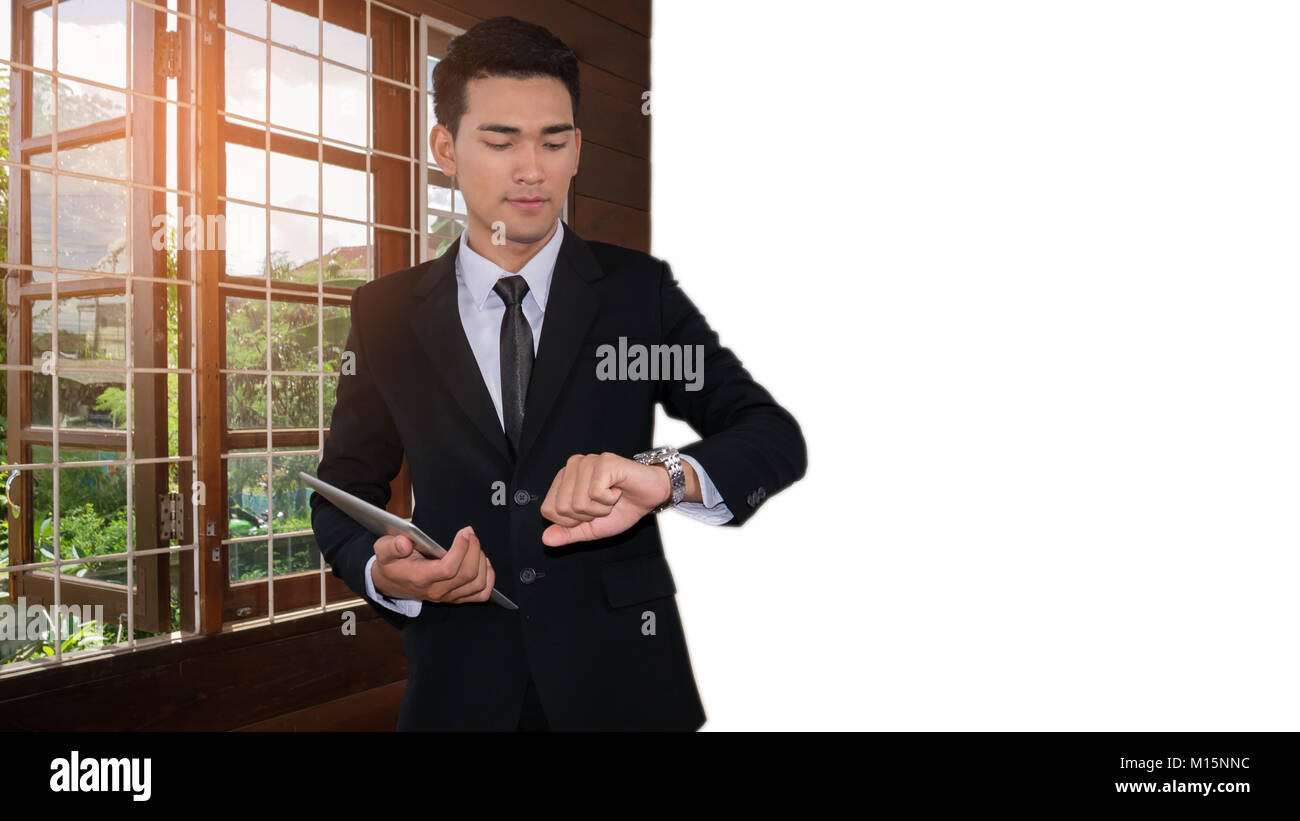asian businessman holding tablet and looking at wrist watch Stock Photo ...