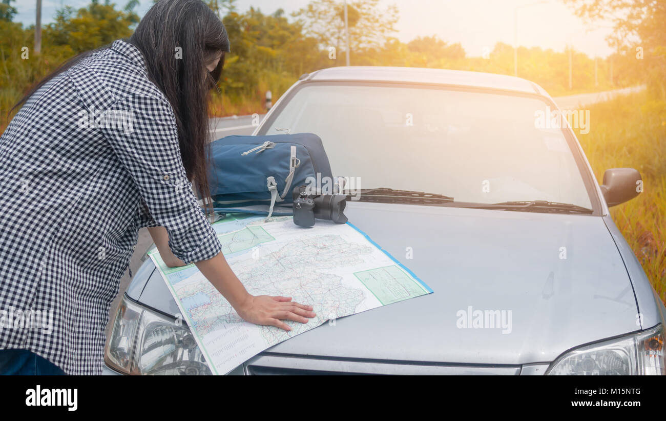 Hipster Asian woman backpacker look map on trip Stock Photo - Alamy