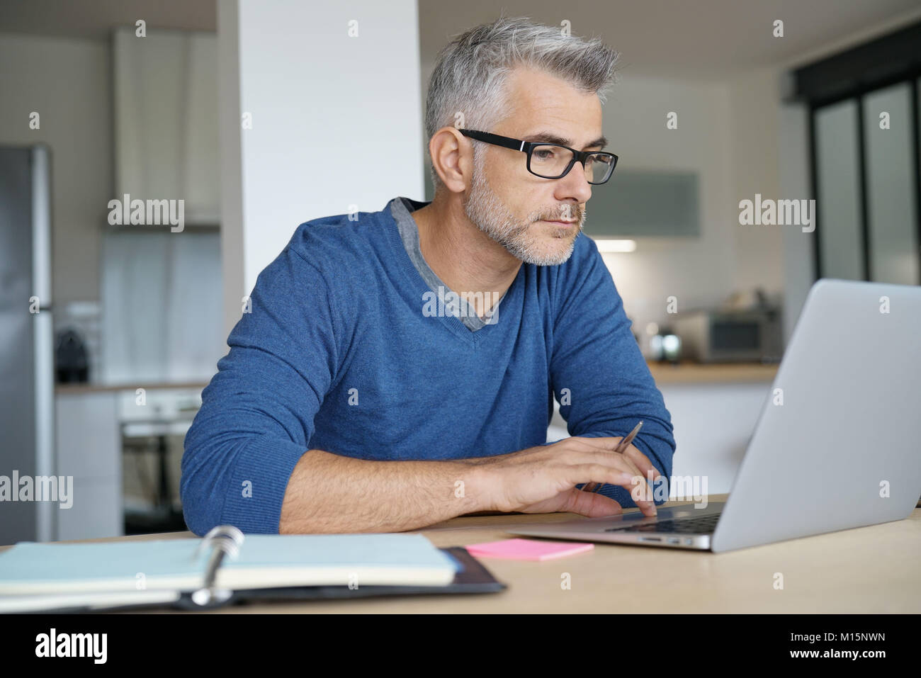 Middle-aged man working from home-office on laptop Stock Photo - Alamy