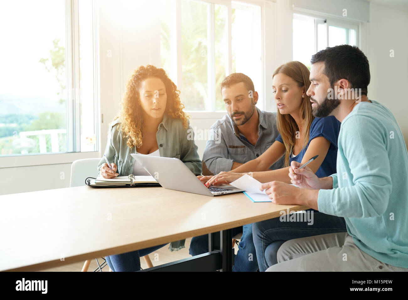 Startup team meeting together around table Stock Photo - Alamy