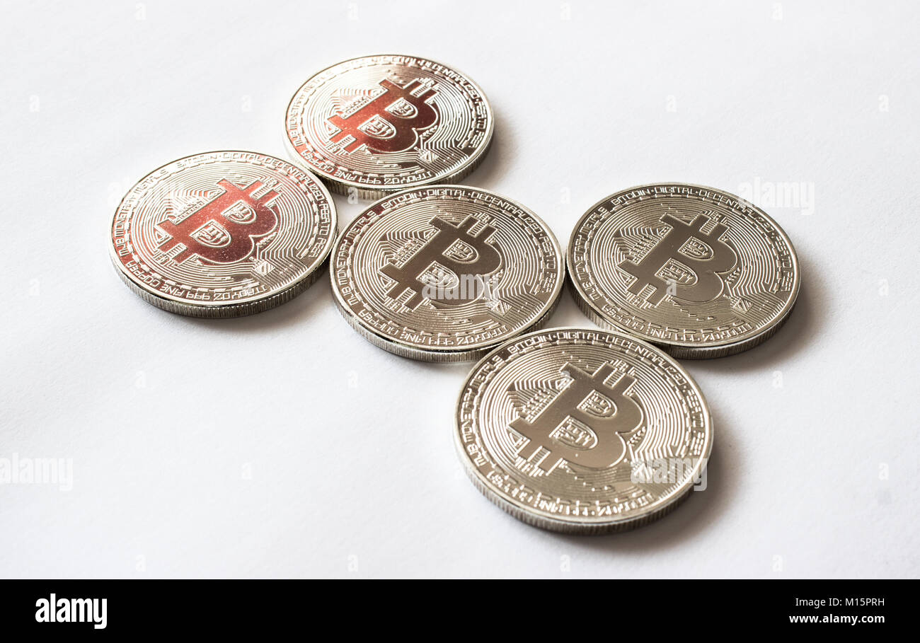 On a grey background are silver coins of a digital crypto currency ...