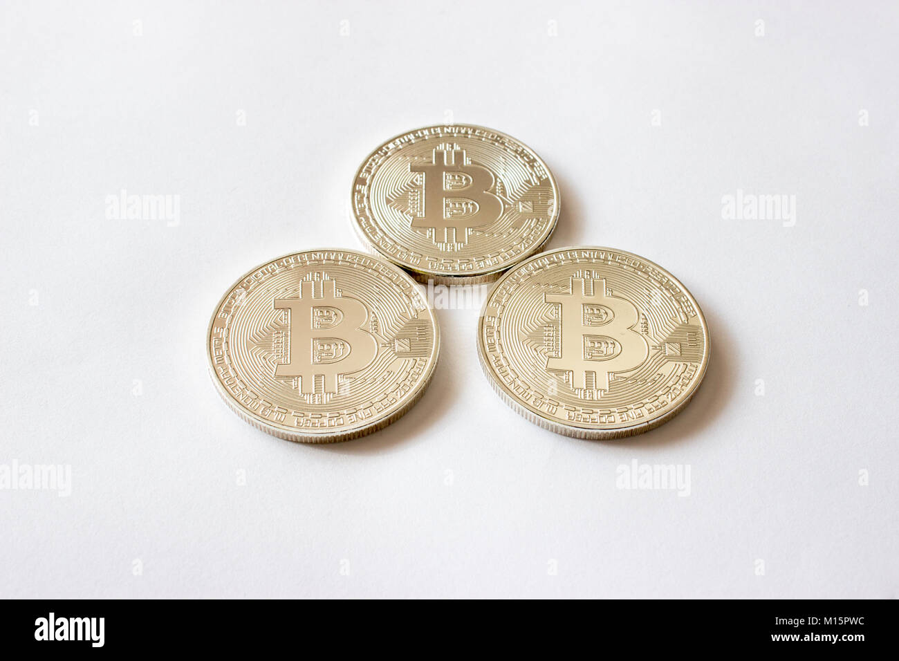 On a grey background are silver coins of a digital crypto currency ...