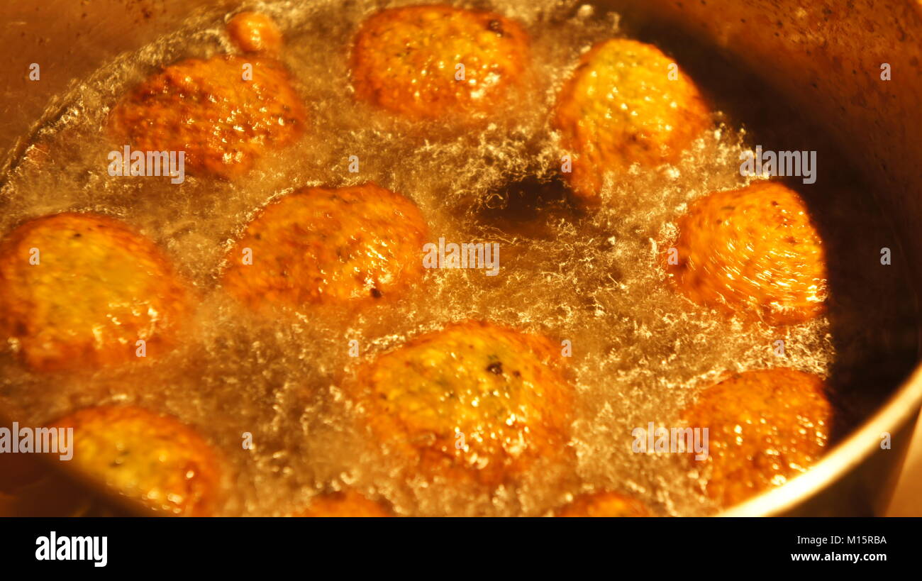 Falafel boiling in the oil, Cooking falafel fresh Stock Photo - Alamy