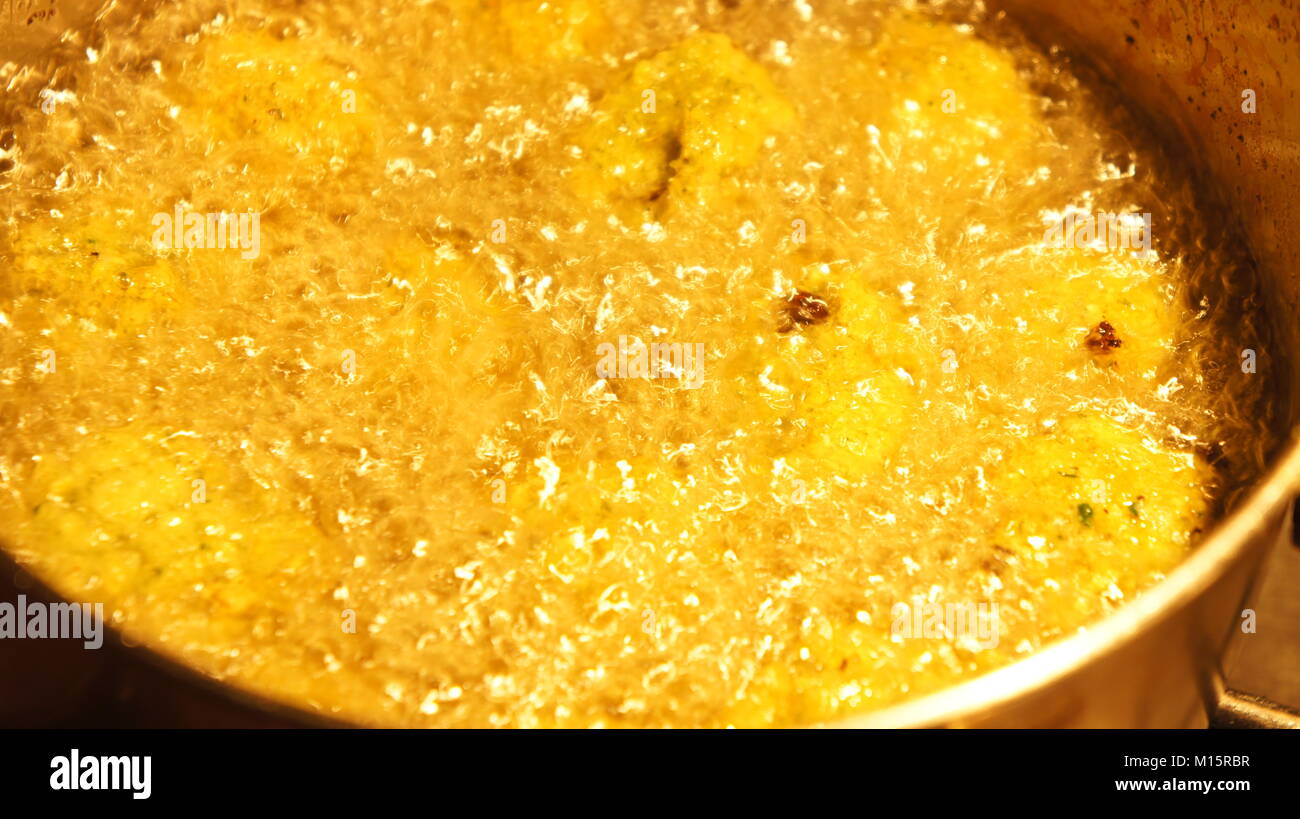 Falafel boiling in the oil, Cooking falafel fresh Stock Photo - Alamy