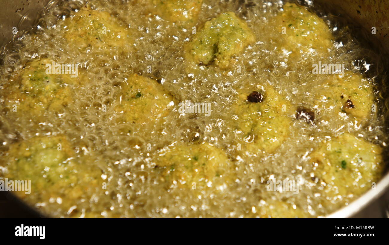 Falafel boiling in the oil, Cooking falafel fresh Stock Photo - Alamy