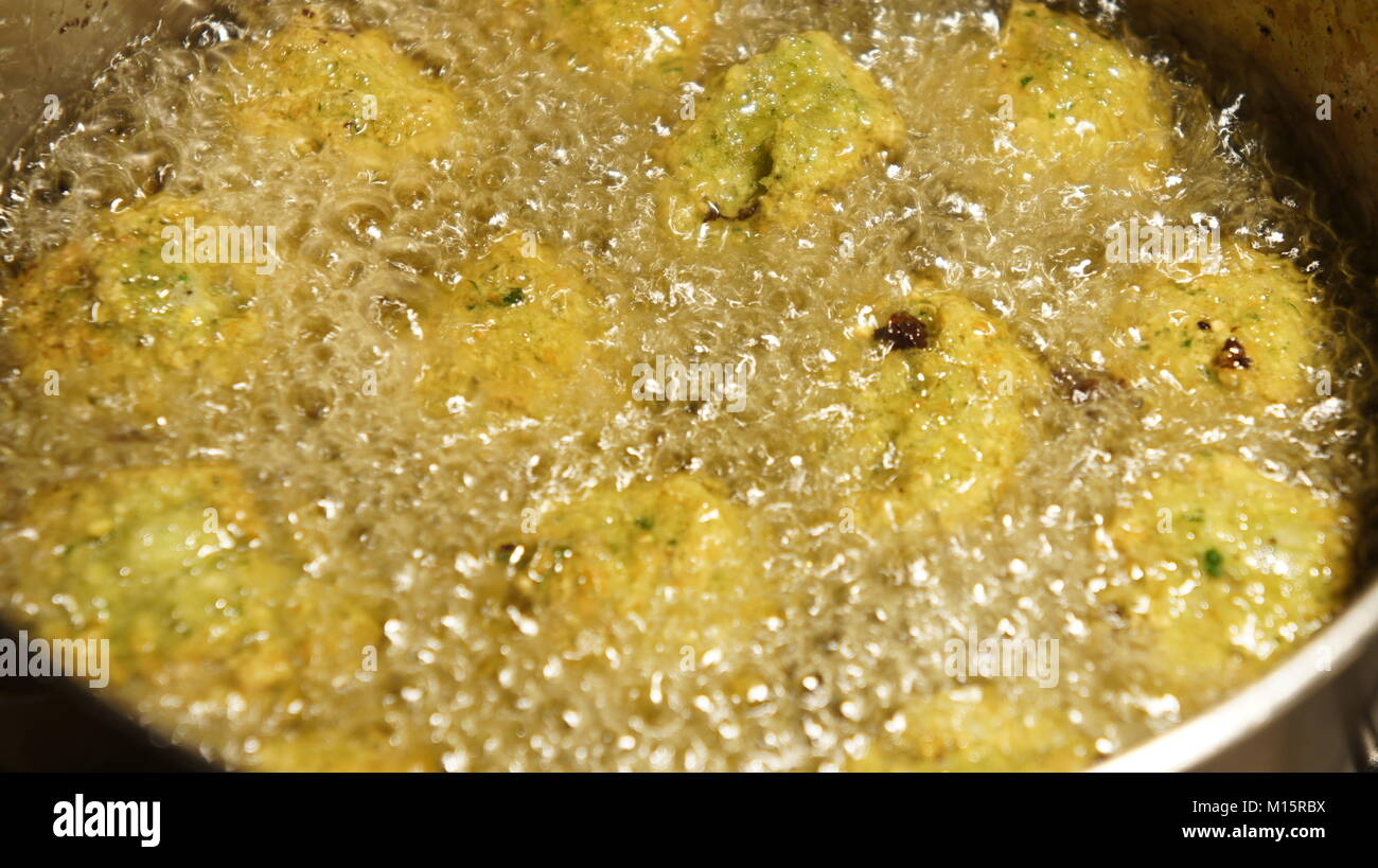 Falafel boiling in the oil, Cooking falafel fresh Stock Photo - Alamy