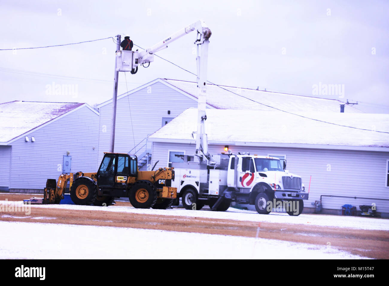 A worker with Xcel Energy takes a look at an electrical connection on a ...