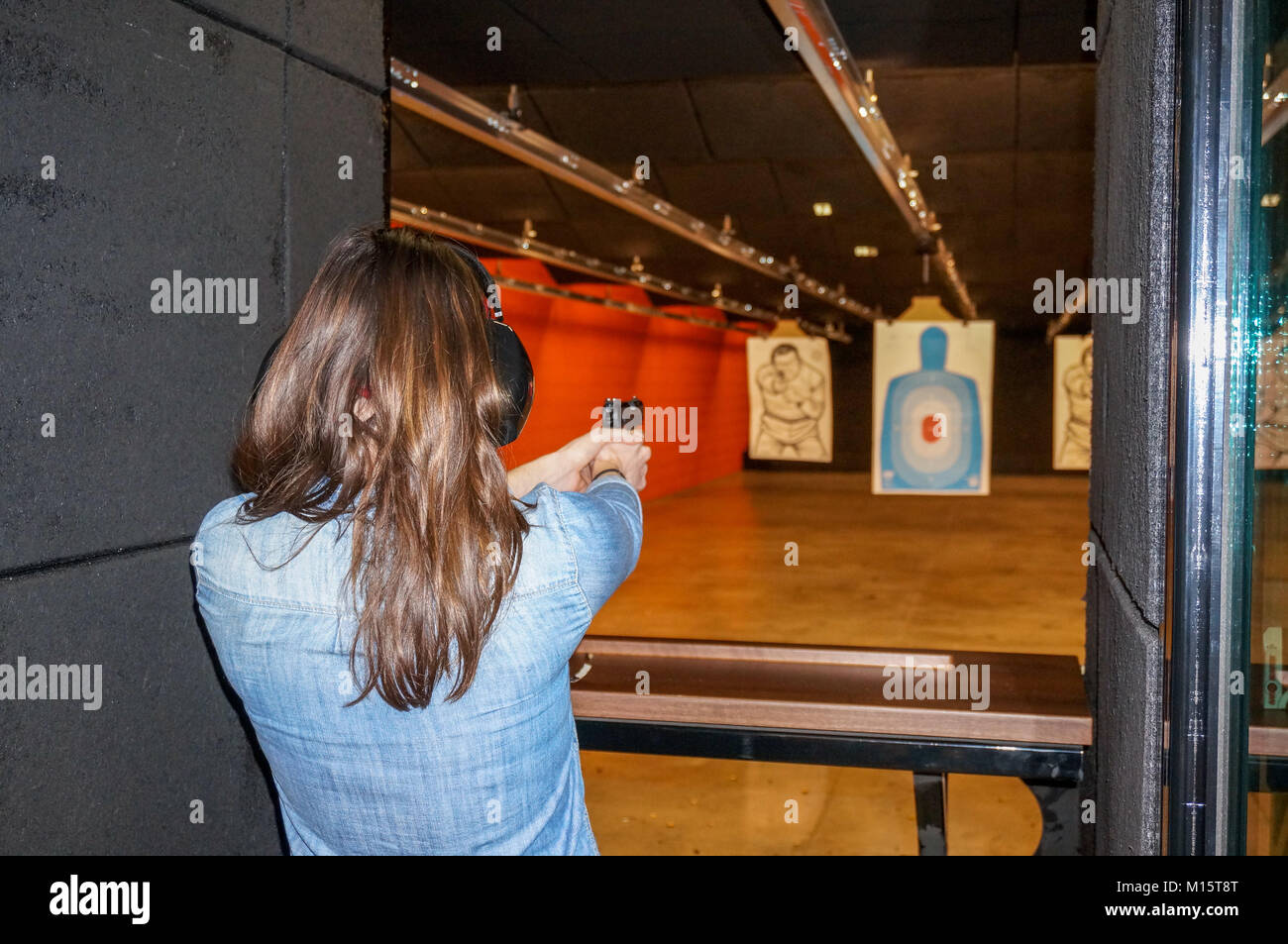 Woman gun firing range hi-res stock photography and images - Alamy