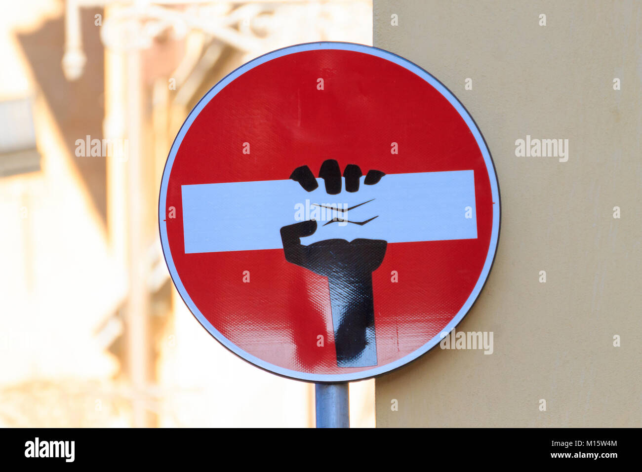 Road sign with an hand that break out the signal, street art ...