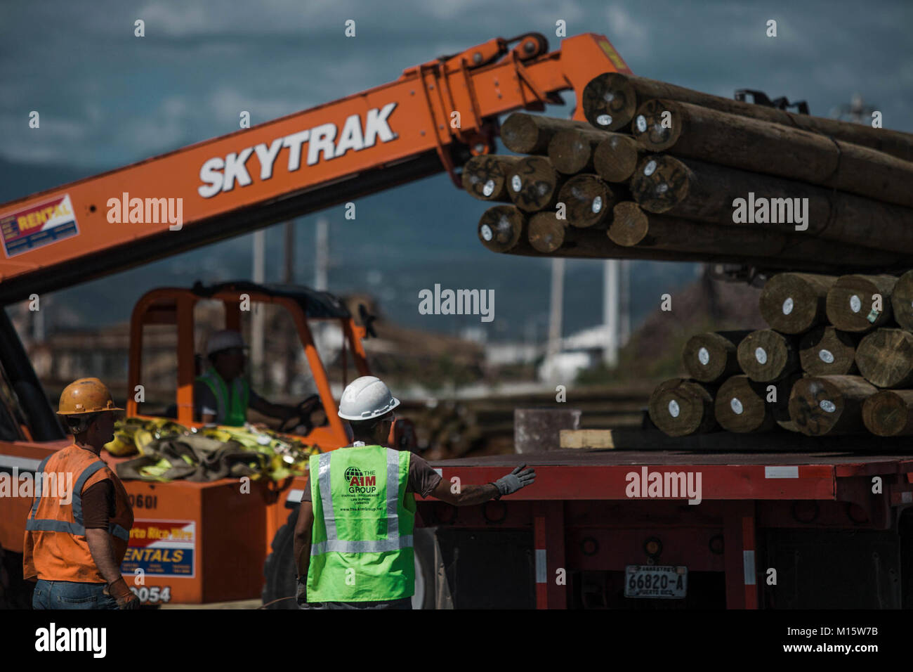 PONCE, Puerto Rico, January 18, 2018 - Workers offload wooden power ...