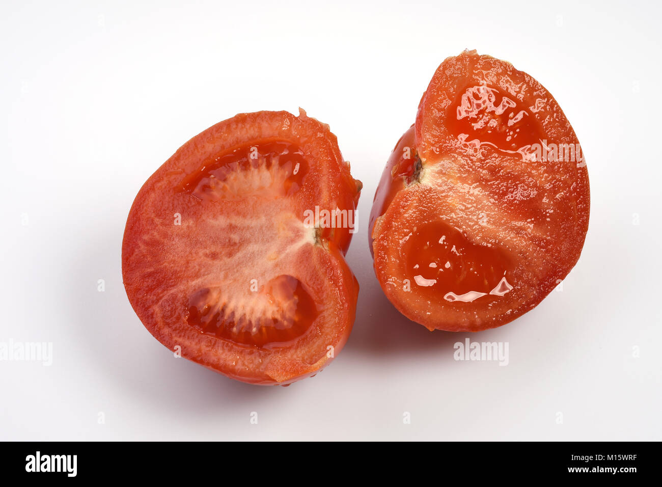 Bright red tomato, cut in half on a white background Stock Photo - Alamy