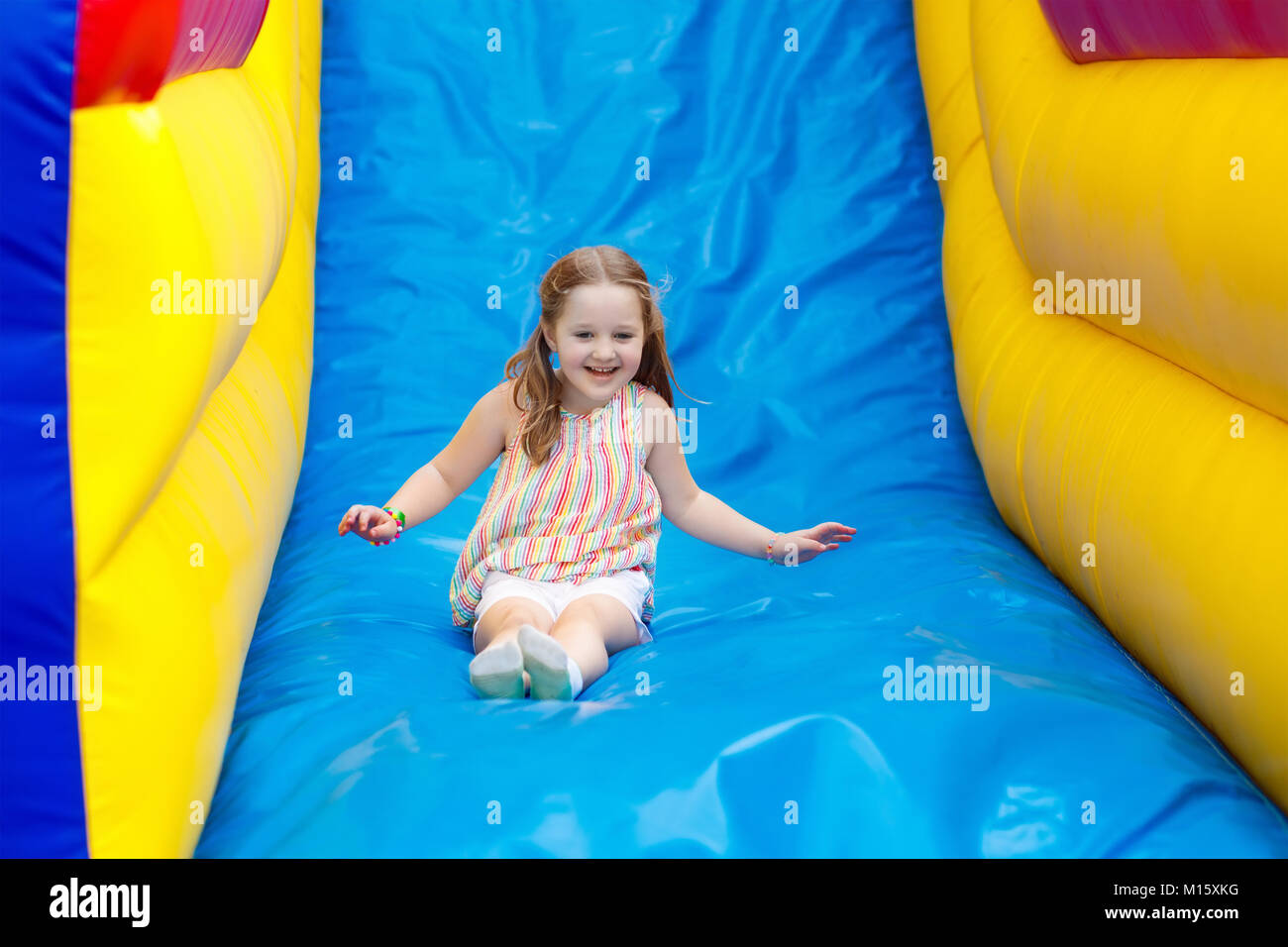 Child jumping on colorful playground trampoline. Kids jump in ...