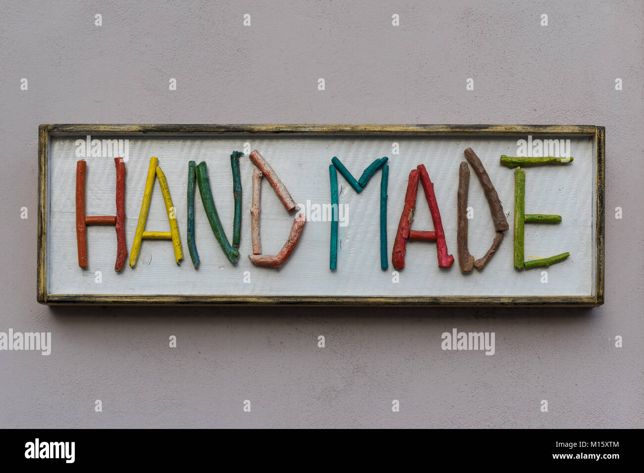 Hand made sign on building facade Stock Photo - Alamy