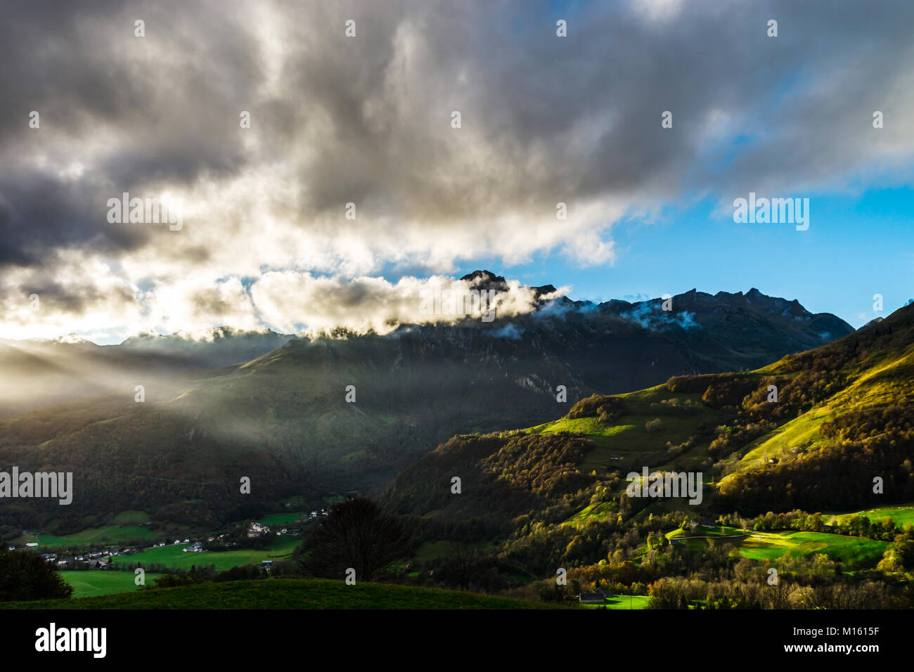Sun rays lighting through the clouds in high Pyrenees, France Stock ...
