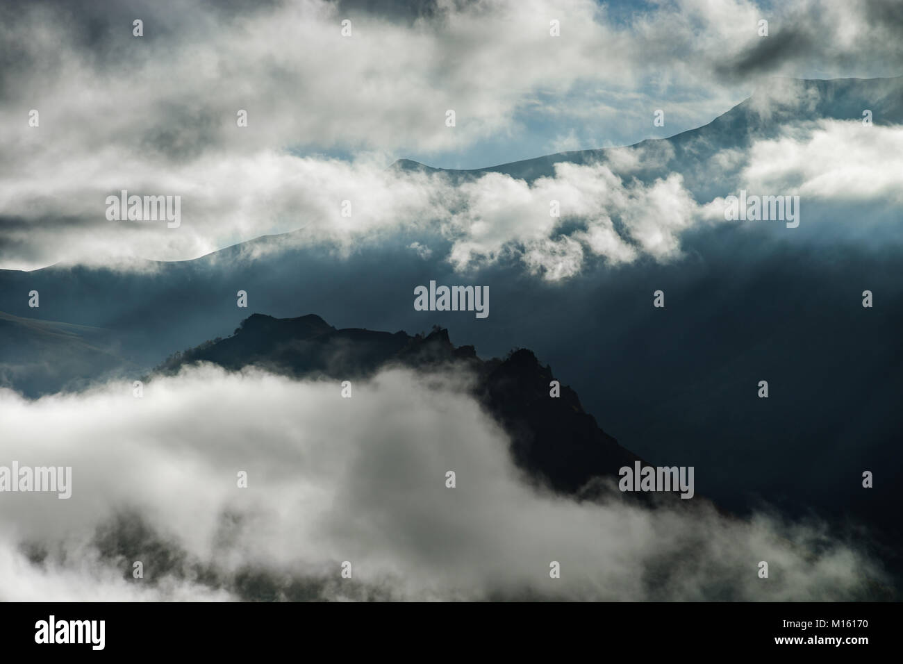 Sun rays lighting through the clouds in high Pyrenees, France Stock ...