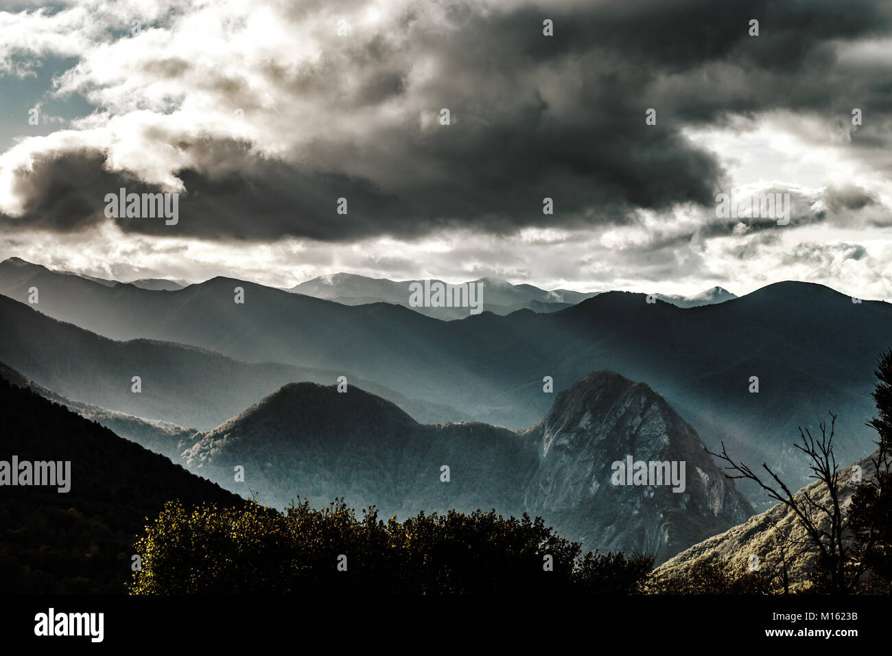 Sun rays lighting through the clouds in high Pyrenees, France Stock ...