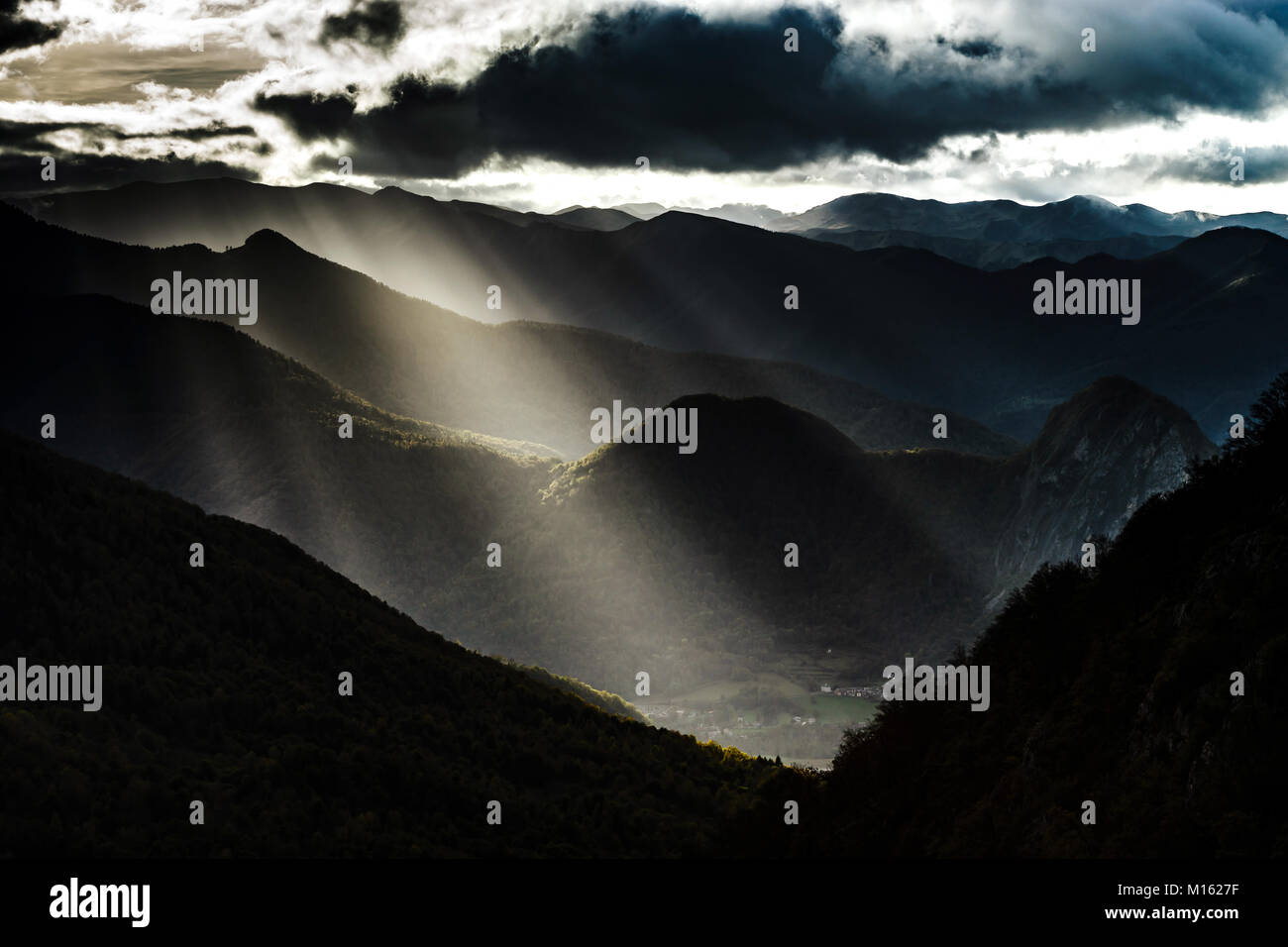 Sun rays lighting through the clouds in high Pyrenees, France Stock ...