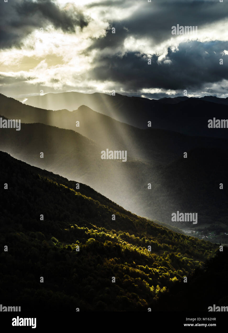 Sun rays lighting through the clouds in high Pyrenees, France Stock ...