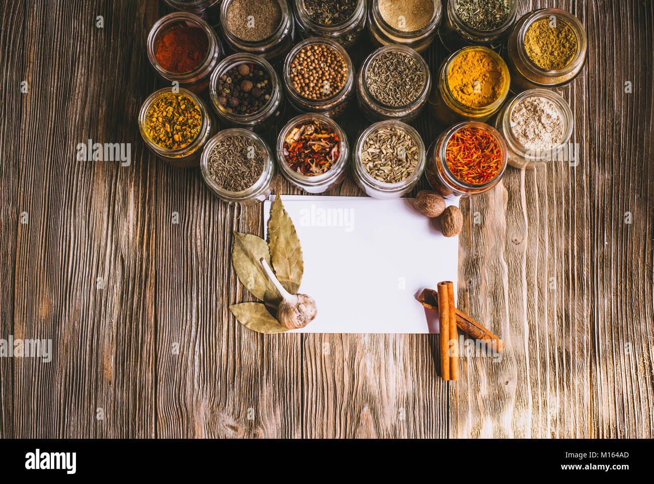Various colorful kinds of spices on rustic wooden table, top view Stock ...
