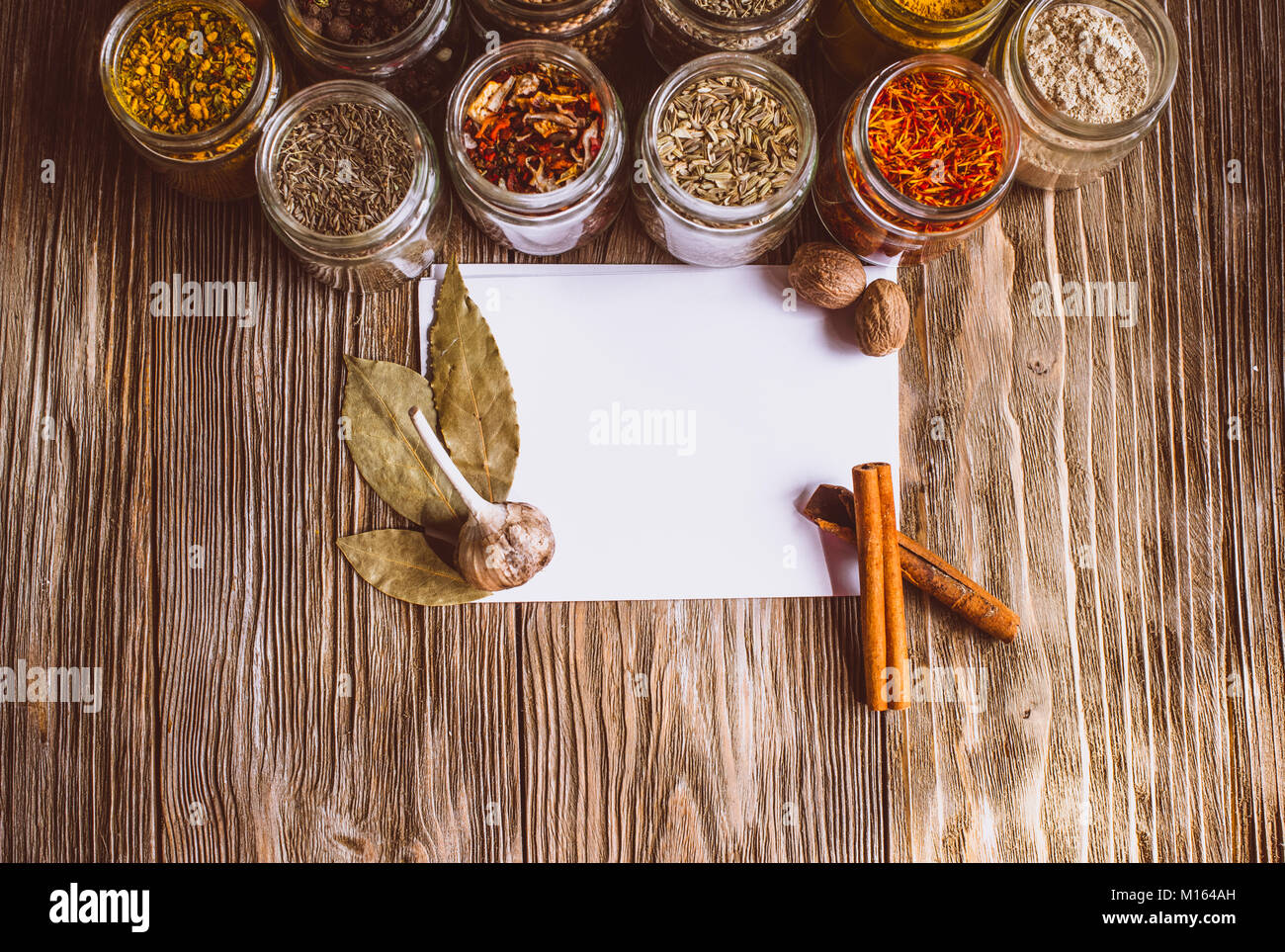 Various colorful kinds of spices on rustic wooden table, top view Stock ...