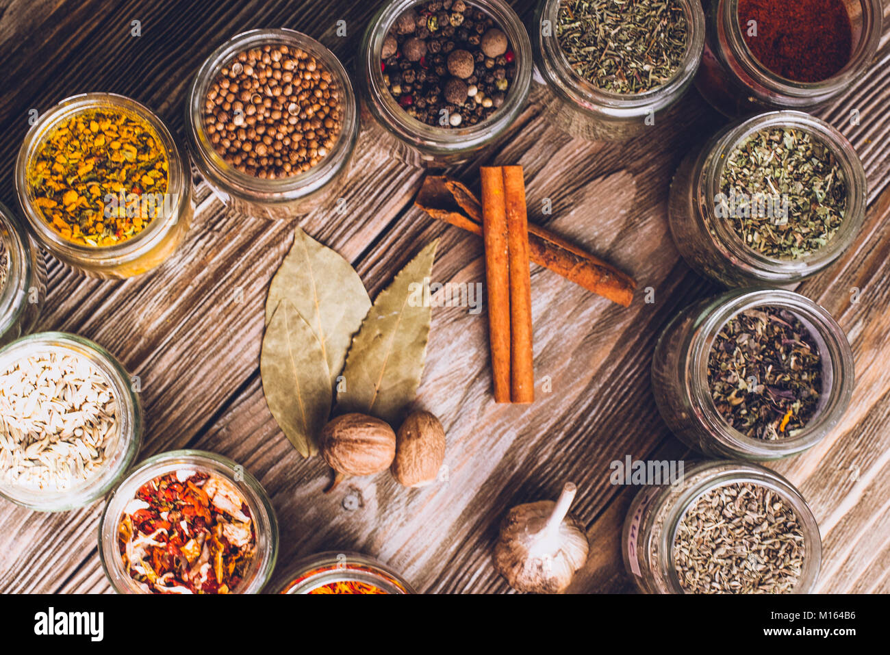 Various colorful kinds of spices on rustic wooden table, top view Stock ...