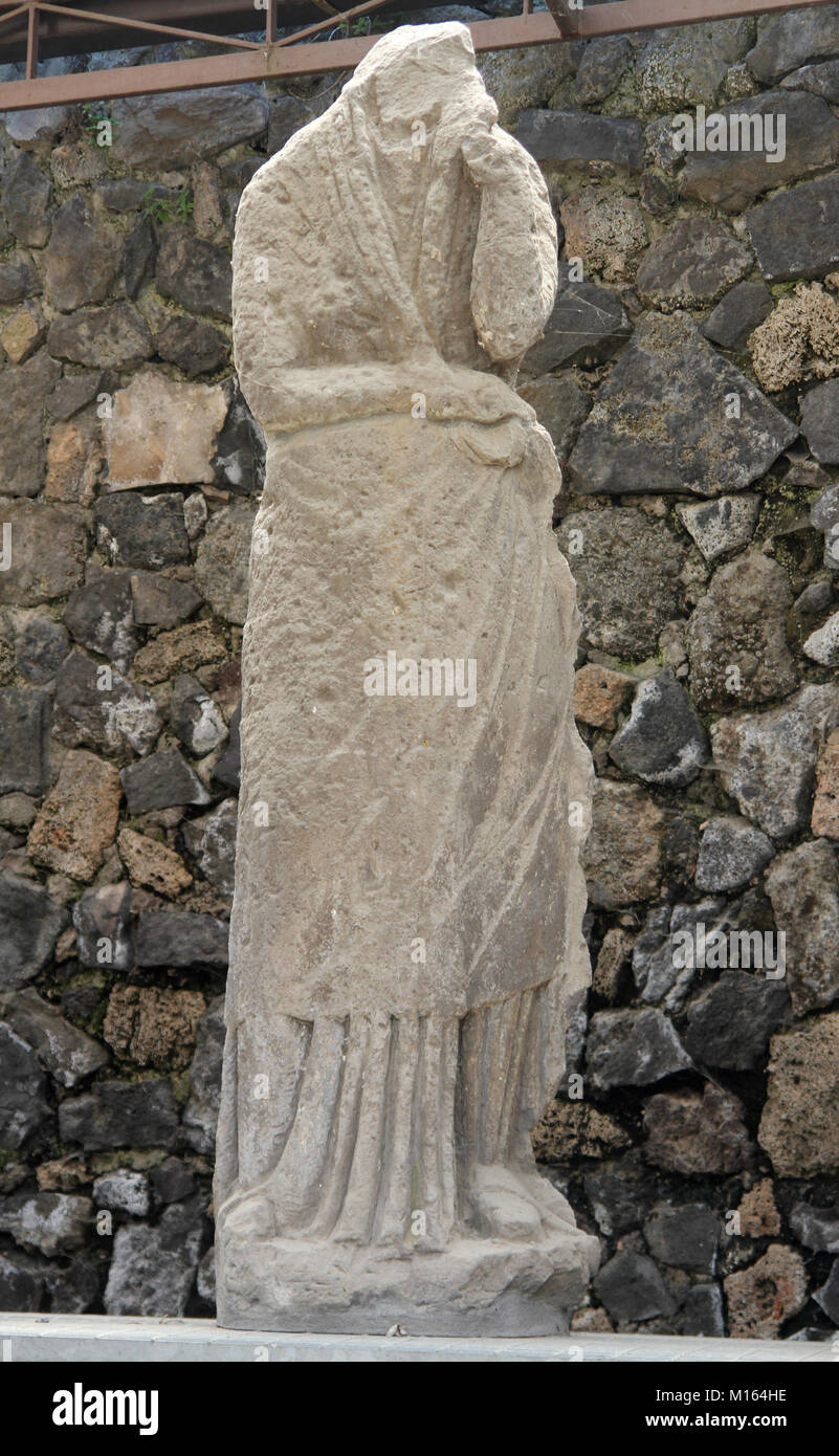 Eroded abandoned headless statue in Porta Nocera in the ancient city of ...