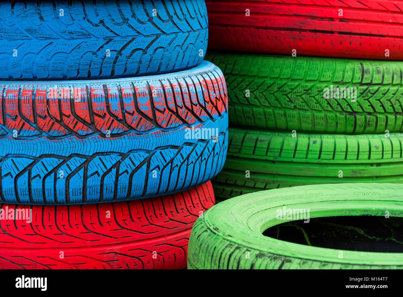 Tires painted in blue, green and red colors Stock Photo - Alamy